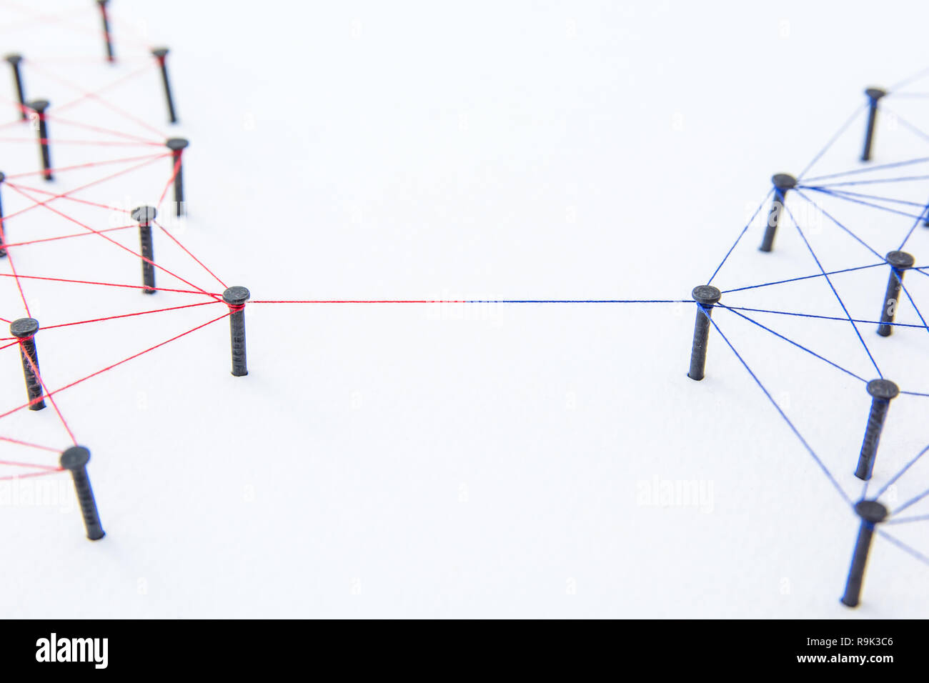 Connecting networks concept - two network connected with yarn red and ...