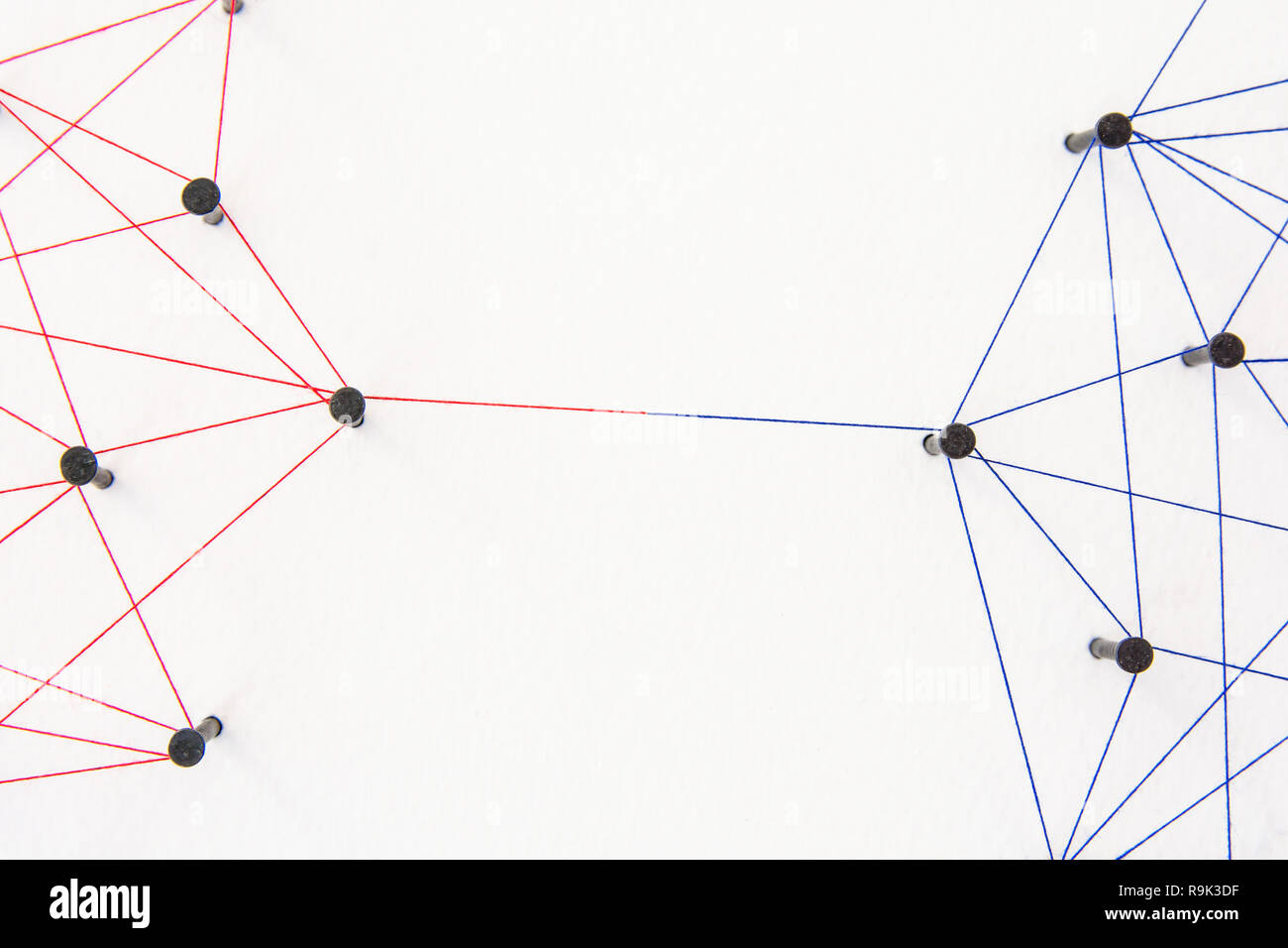 Connecting networks concept - two network connected with yarn red and ...