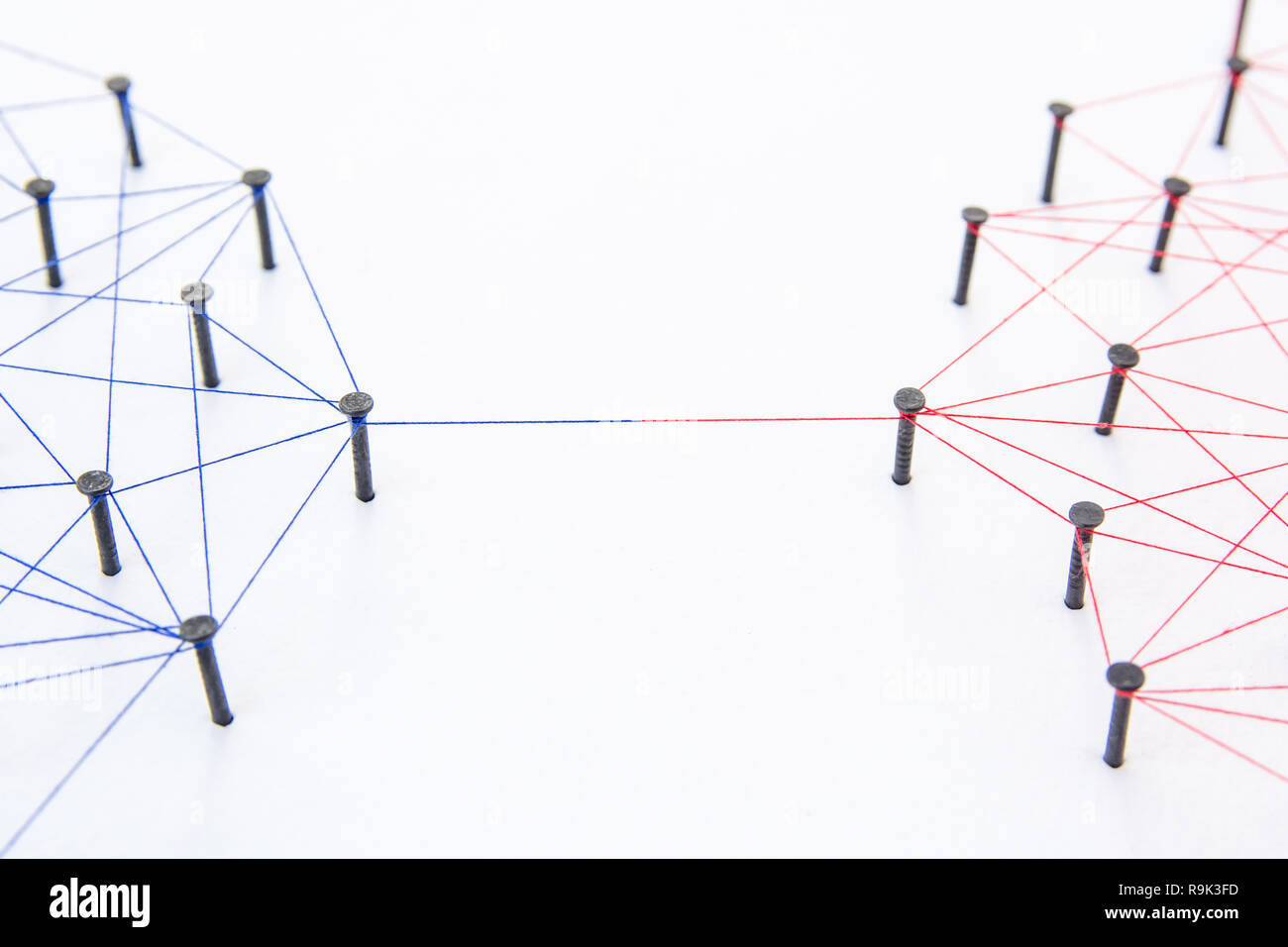 Connecting networks concept - two network connected with yarn red and ...