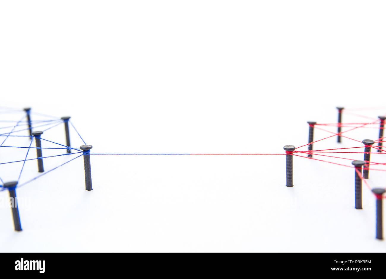 Connecting networks concept - two network connected with yarn red and ...