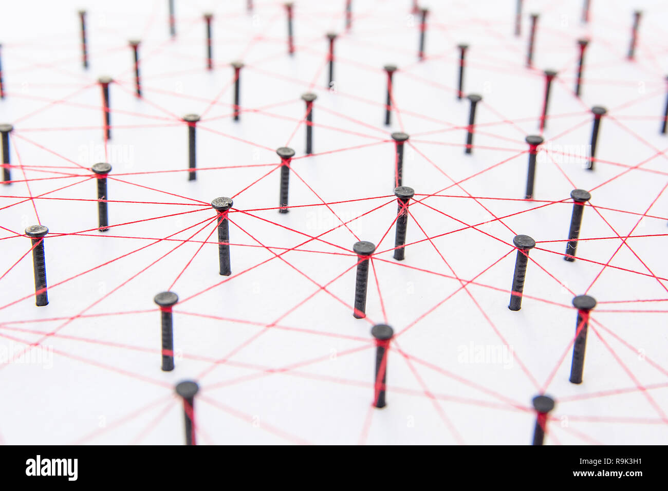 Connecting networks concept - network connected with yarn red on white ...