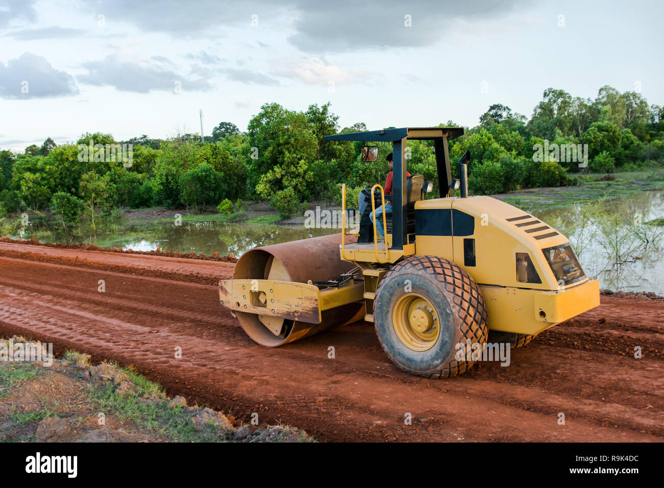 Roller steamroller or vibratory roller machine working on road ...