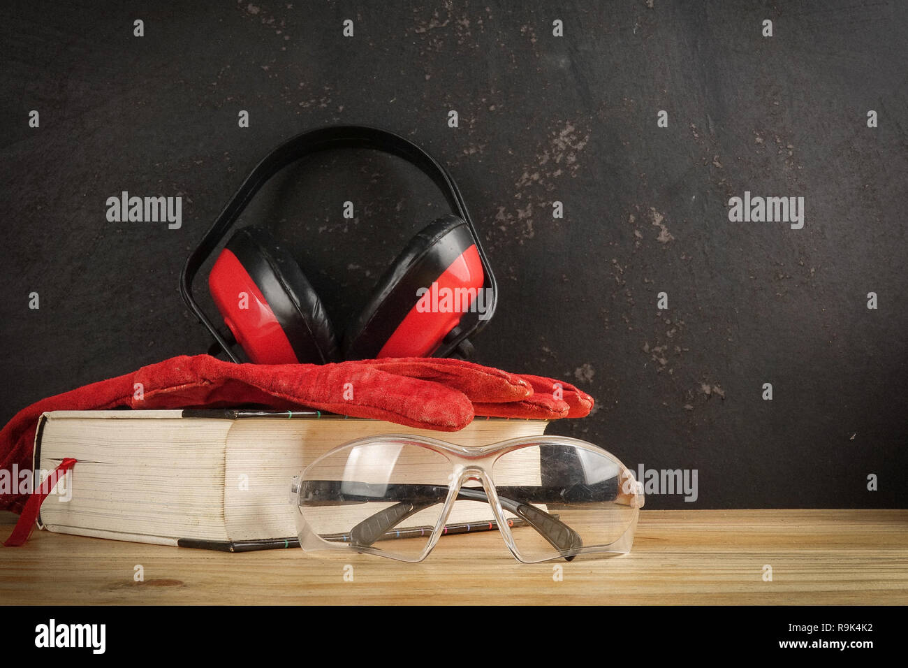 Safety Personal Protective Equipment(PPE) on a rustic black background ...