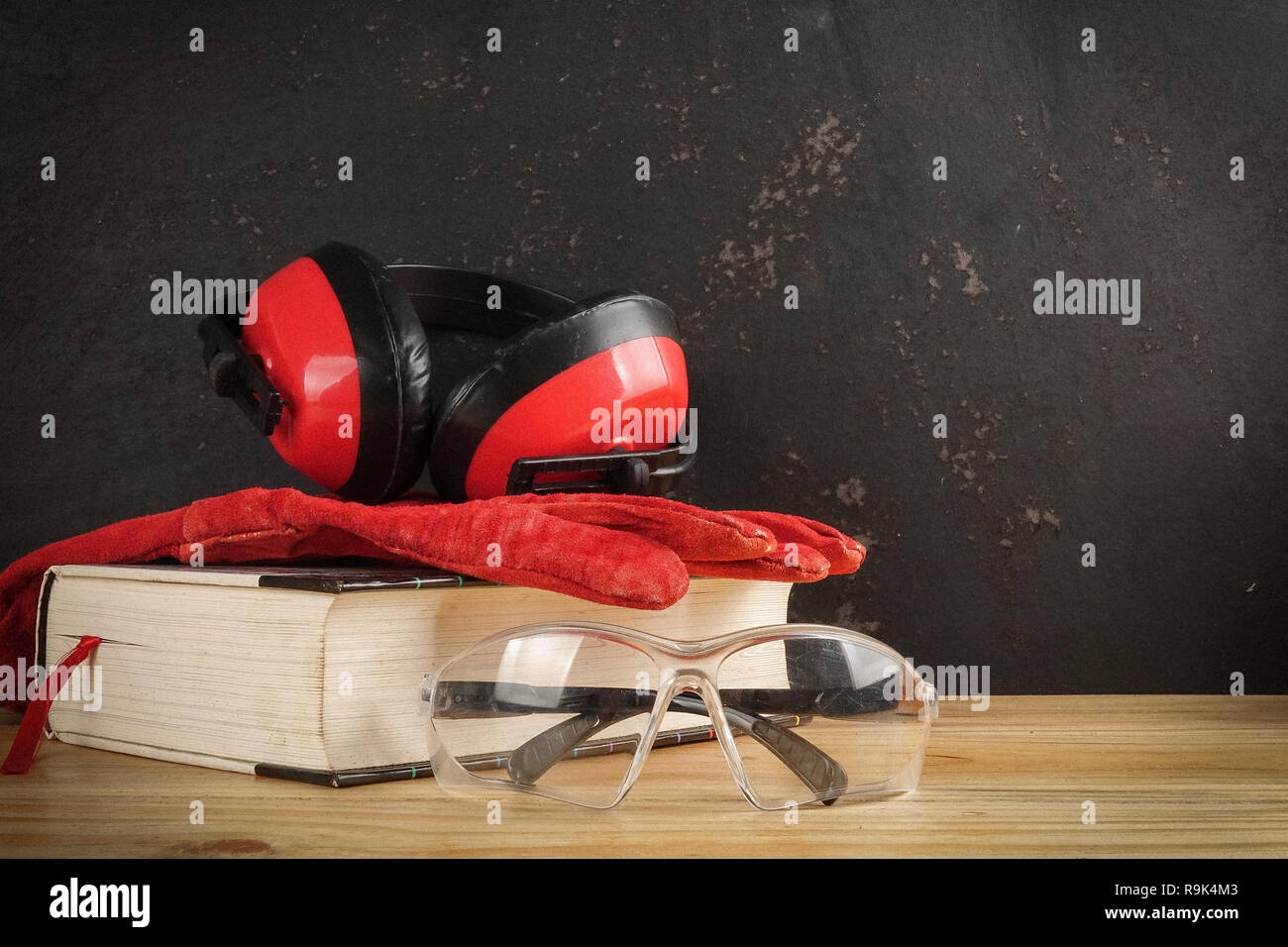 Safety Personal Protective Equipment(PPE) on a rustic black background ...