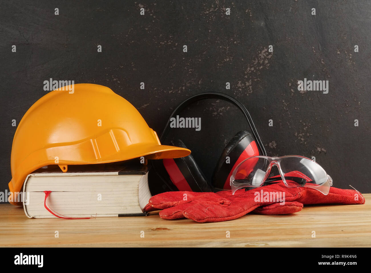 Safety Personal Protective Equipment(PPE) on a rustic black background ...
