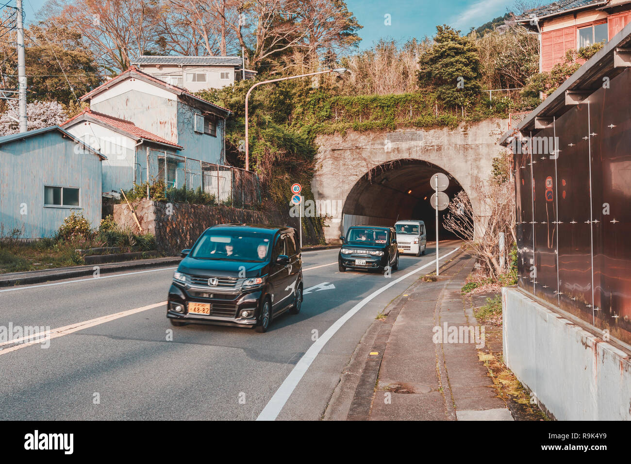 Three car passing through a tunnel in Uchiura on a sunny day with ...