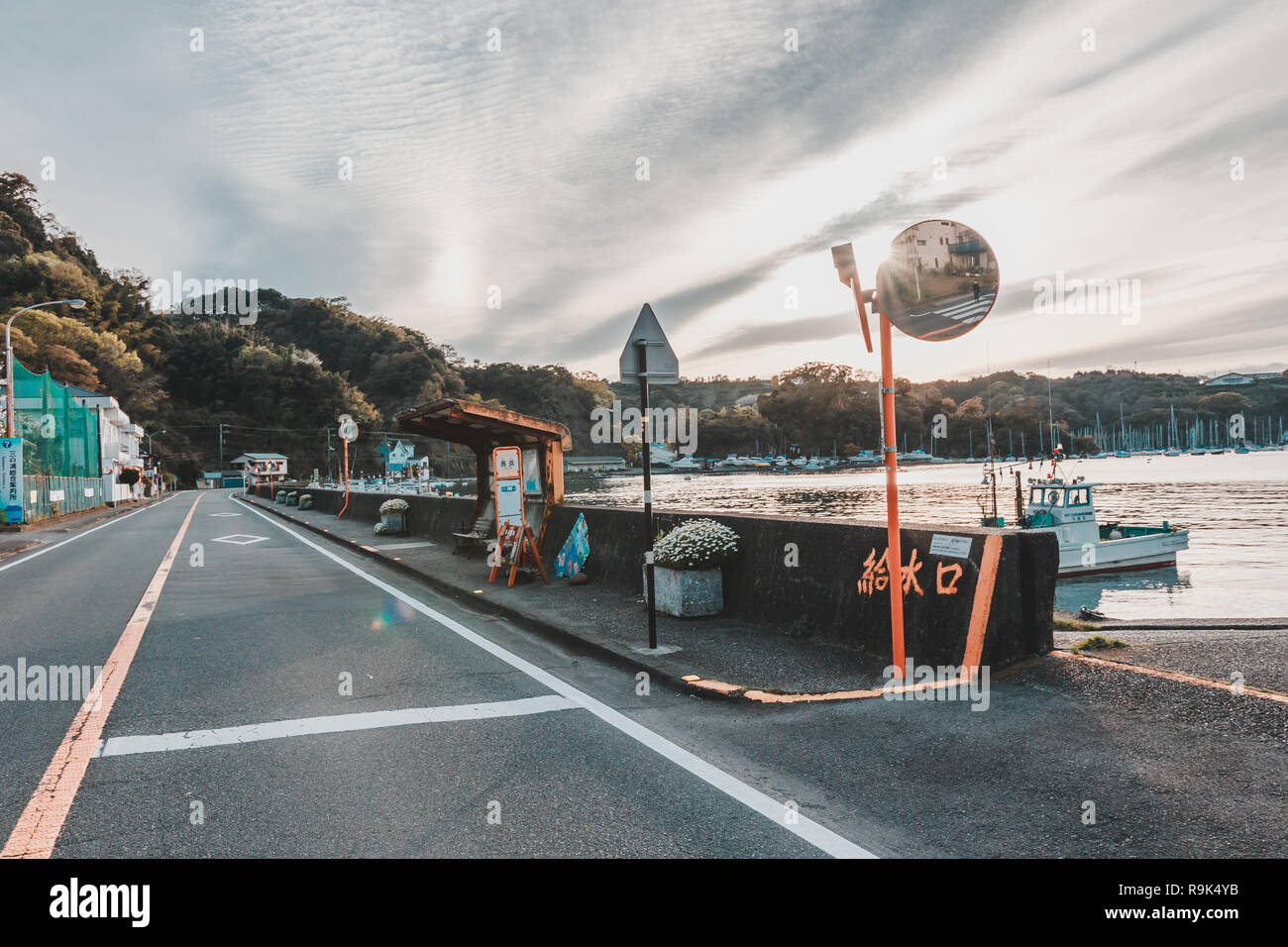 a Japanese bus stop in Uchiura with Uchiura bay in the background on a ...