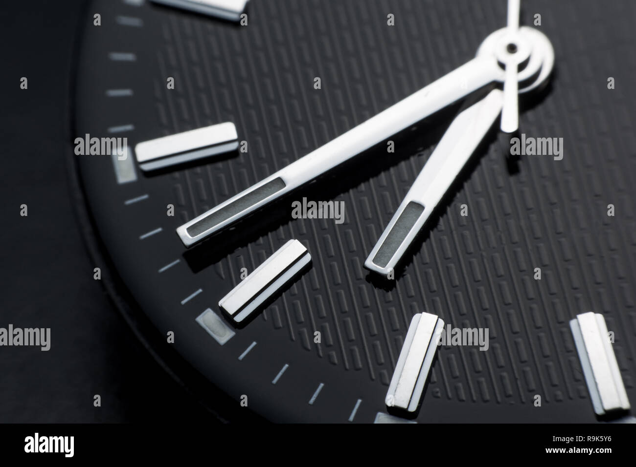 Close up clockwise on black clock face background. Wristwatch in retro ...