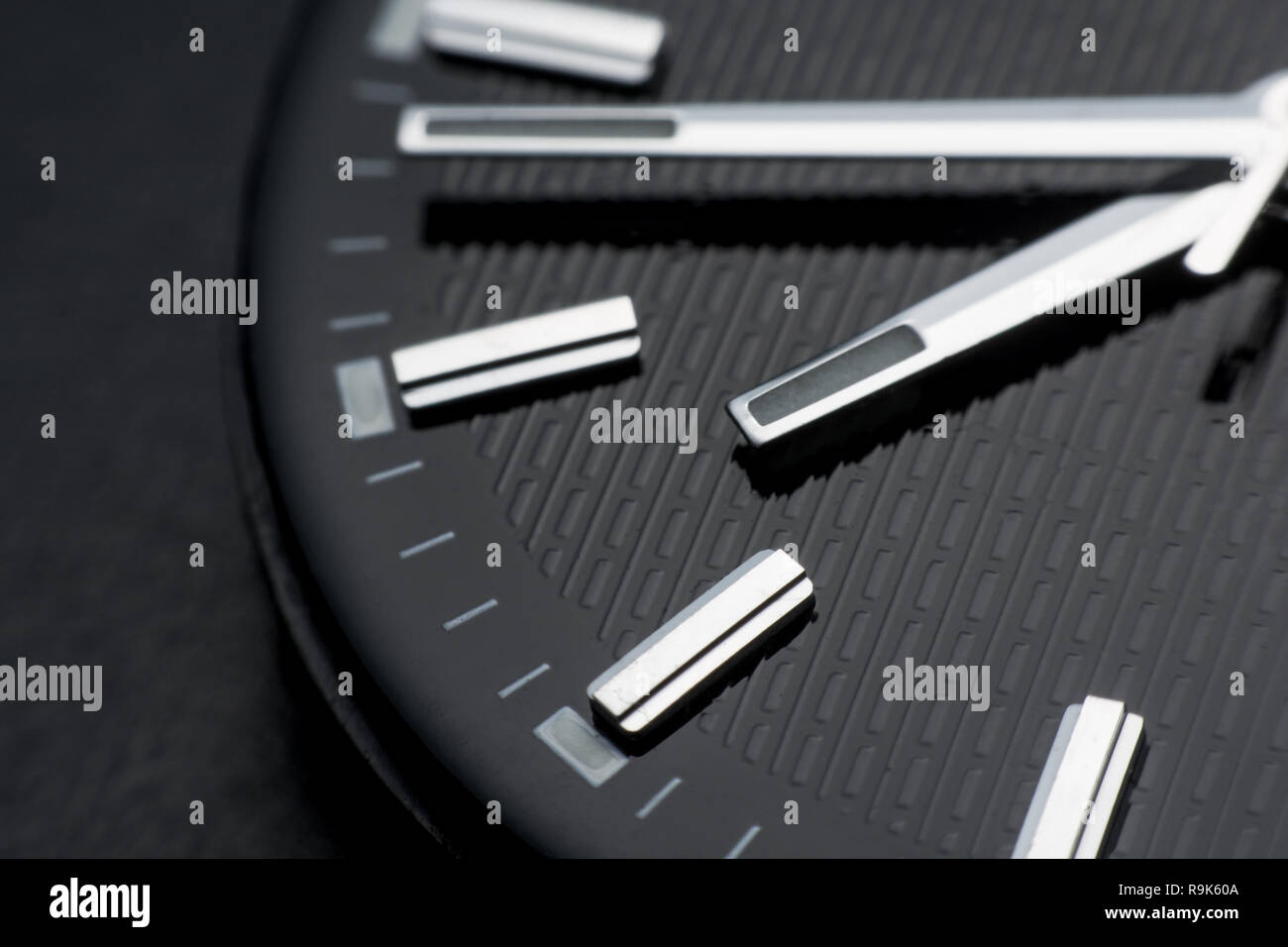 Close up clockwise on black clock face background. Wristwatch in retro ...