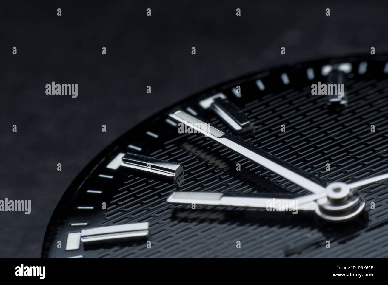 Close up clockwise on black clock face background. Wristwatch in retro ...