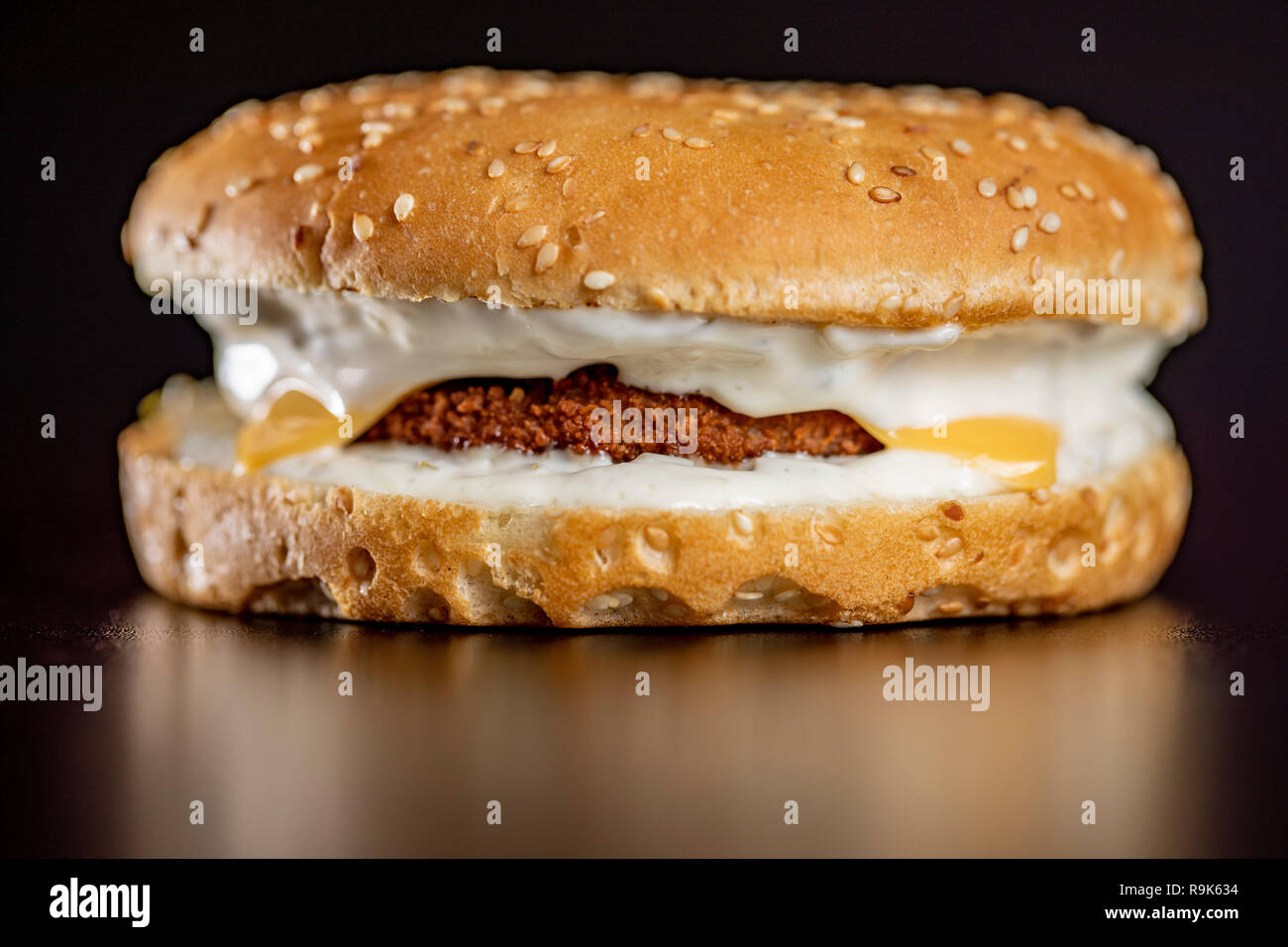 Fish burger close up on isolated black background Stock Photo - Alamy