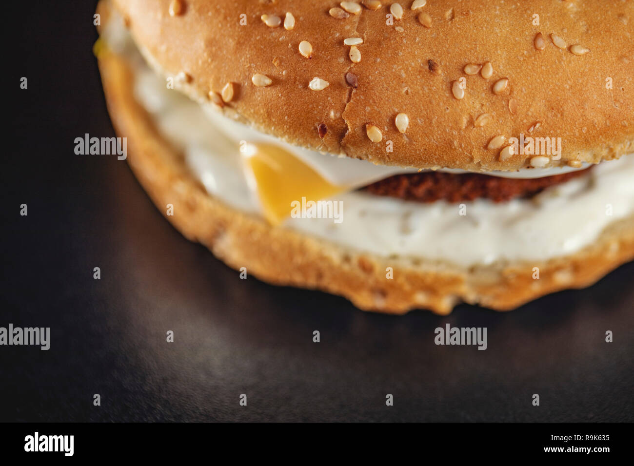 Fish burger close up on isolated black background Stock Photo - Alamy