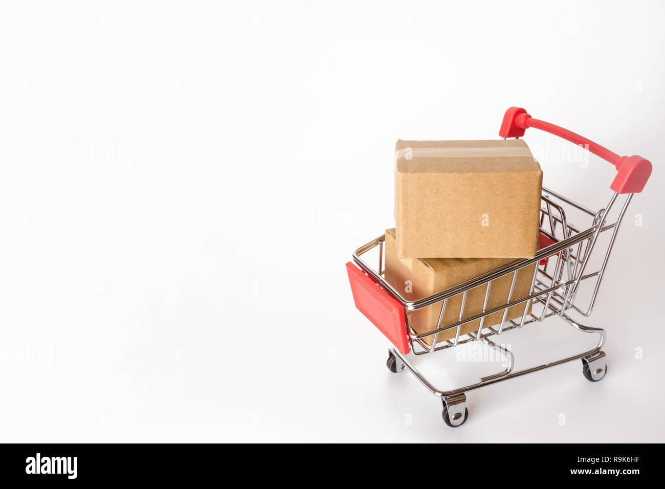 Shopping concept : Cartons or Paper boxes in red shopping cart on white ...