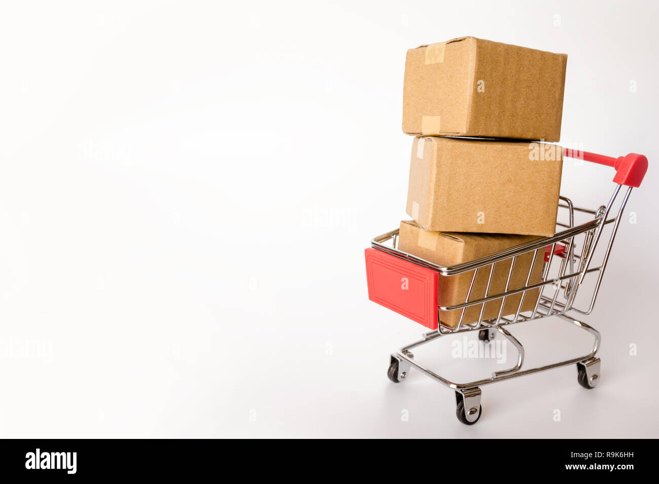 Shopping concept : Cartons or Paper boxes in red shopping cart on white ...