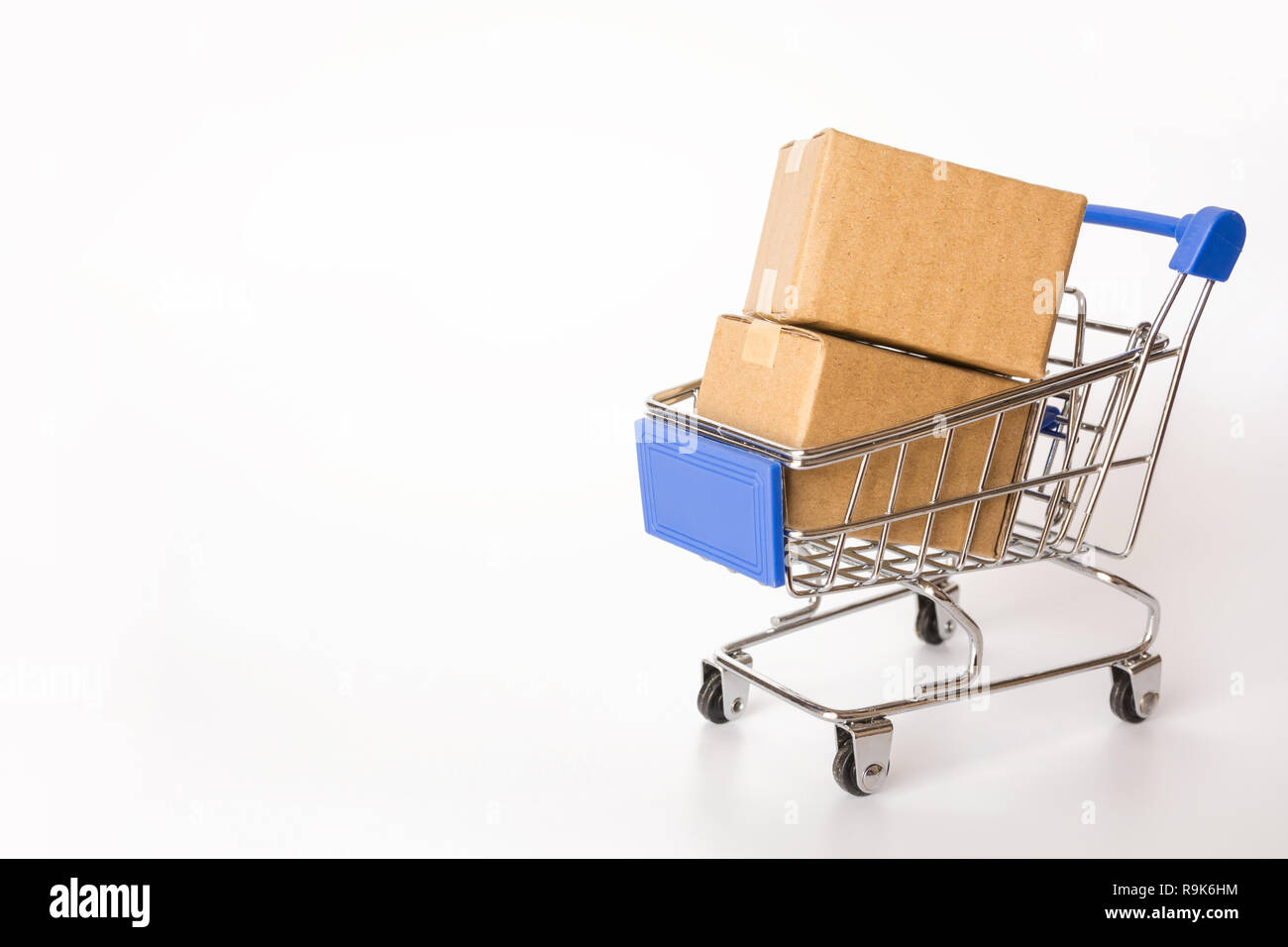 Shopping concept : Cartons or Paper boxes in blue shopping cart on ...