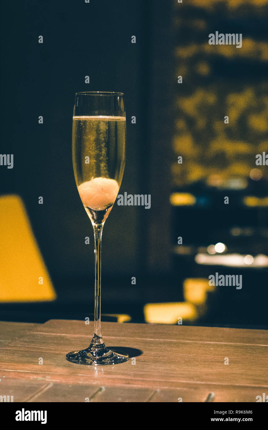 Champagne cocktail with lychee in a flute Stock Photo - Alamy