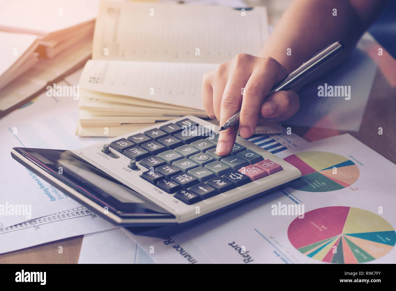 Business concep : close up woman hand using calculator and writing make ...