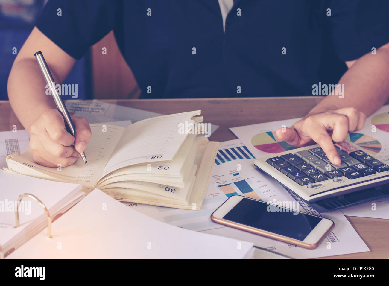 Business concep : close up woman hand using calculator and writing make ...