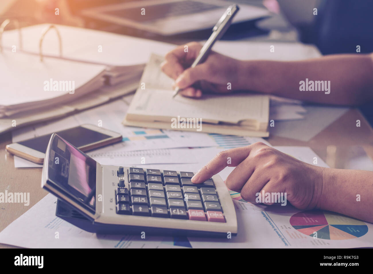 Business concep : close up woman hand using calculator and writing make ...