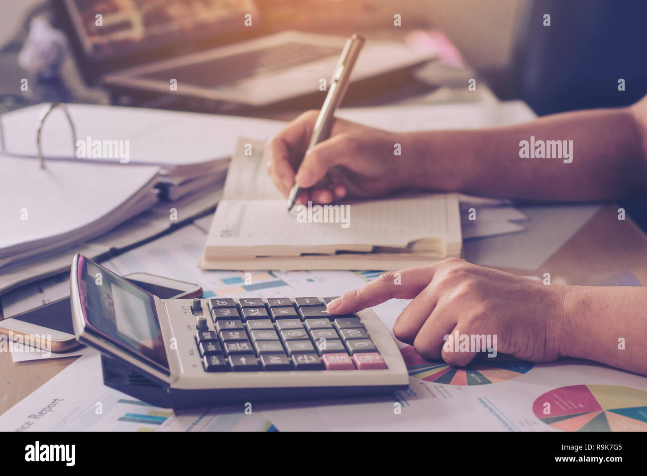 Business concep : close up woman hand using calculator and writing make ...