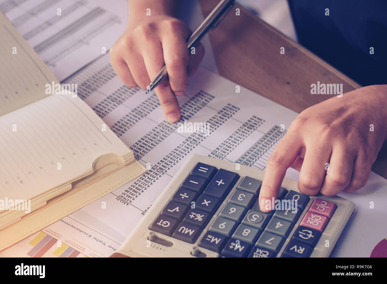 Business concep : close up woman hand using calculator and writing make ...