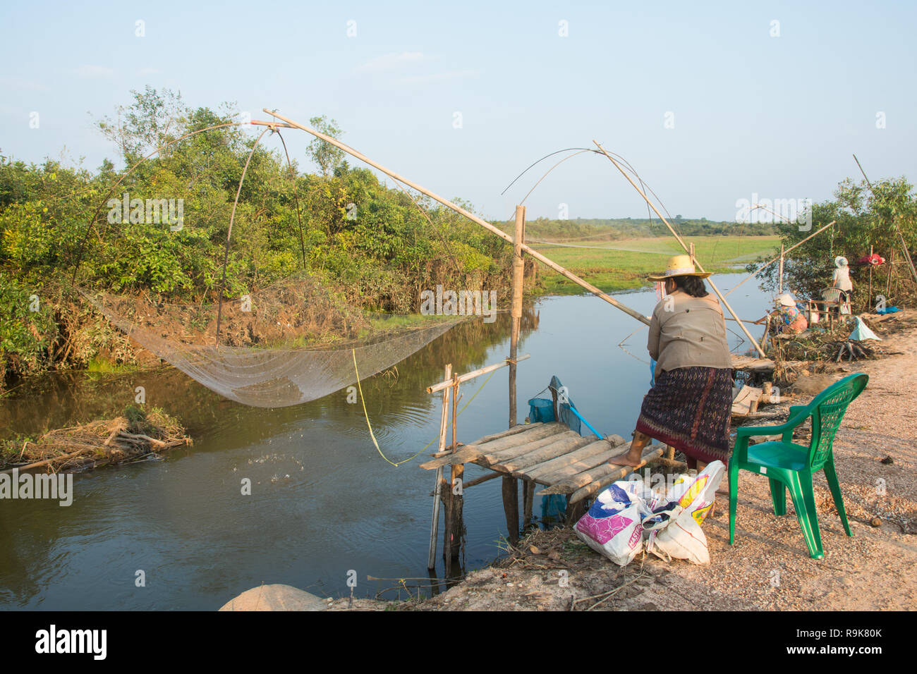 Nakhon Phanom, Thailand - 14 September 2018 : old woman catch fish with ...