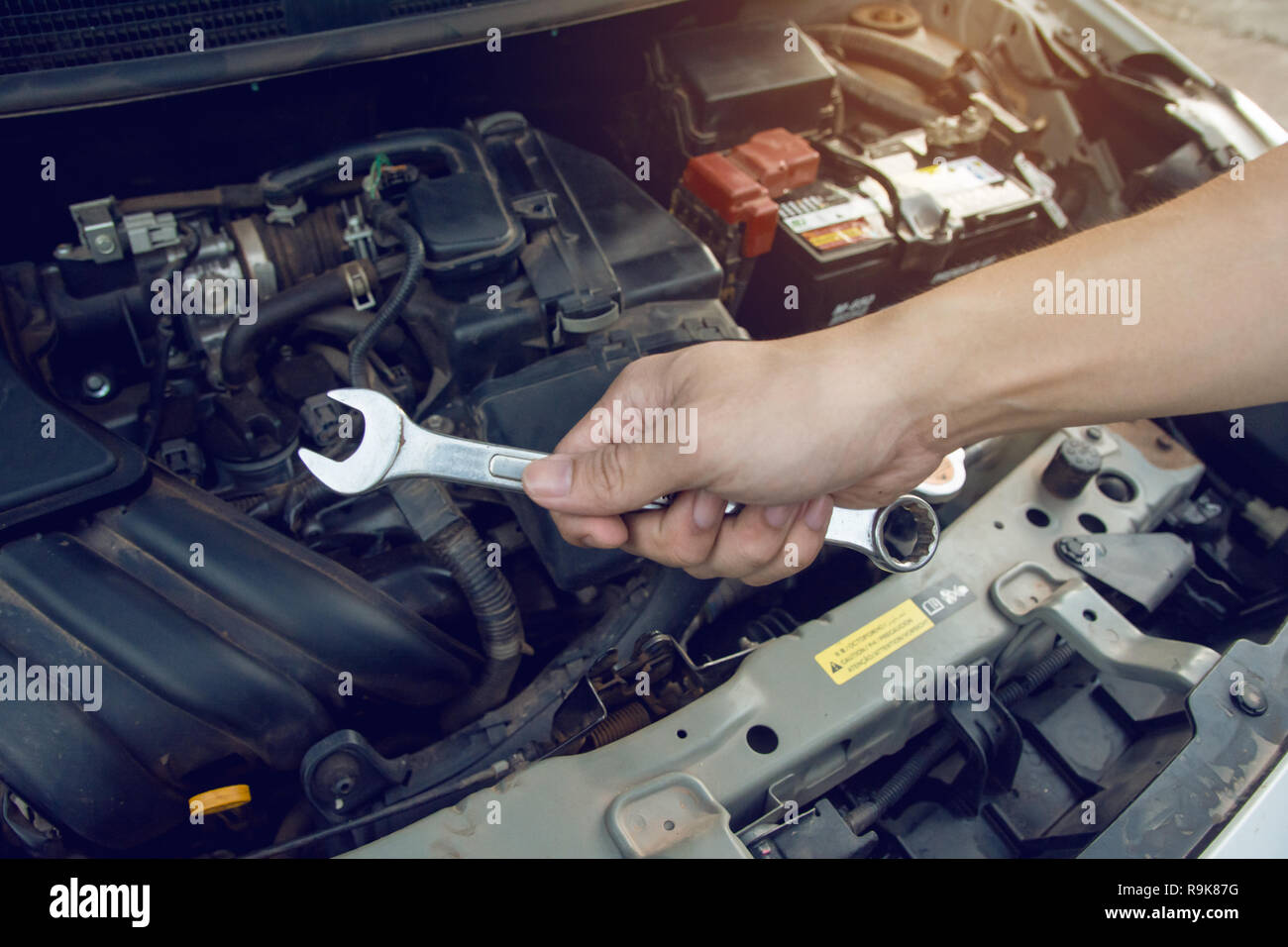 Car mechanic working with wrench in garage. Repair service Stock Photo ...