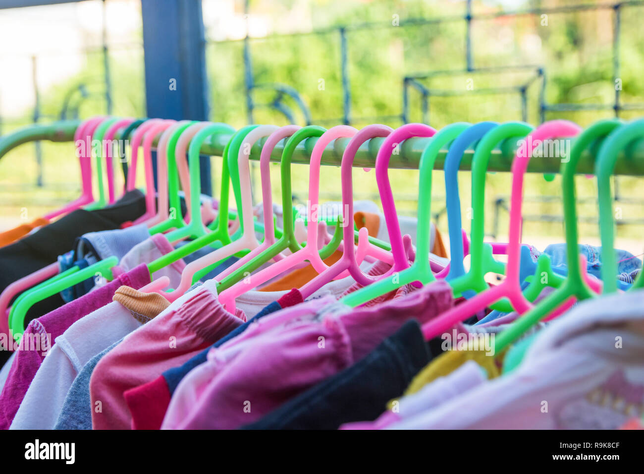 Colorful clothes Hanger on a shelf Stock Photo - Alamy