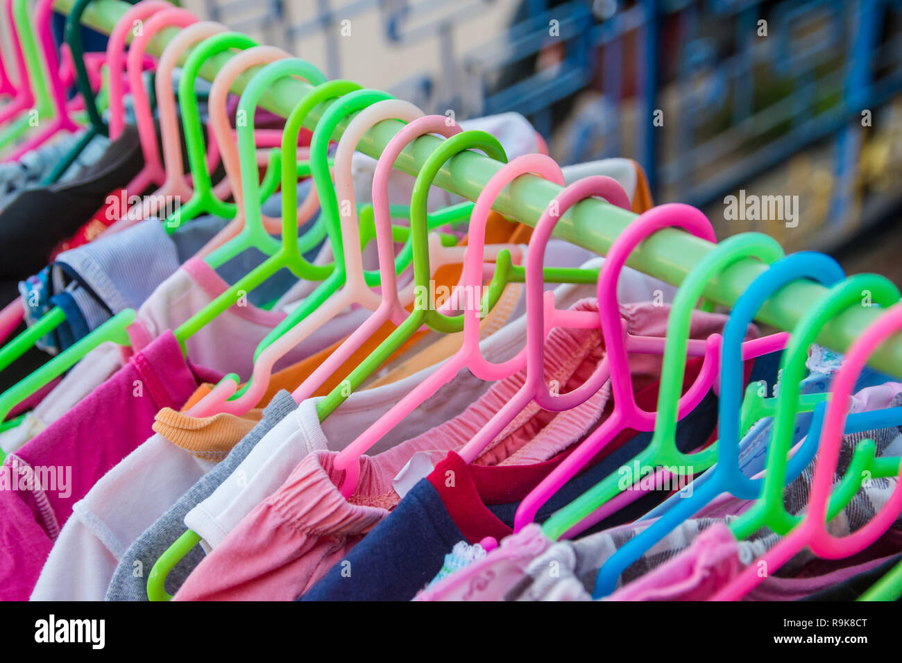 Colorful clothes Hanger on a shelf Stock Photo - Alamy