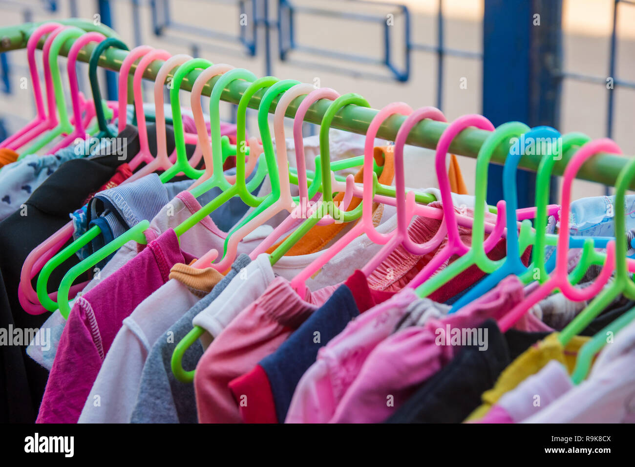 Colorful clothes Hanger on a shelf Stock Photo - Alamy