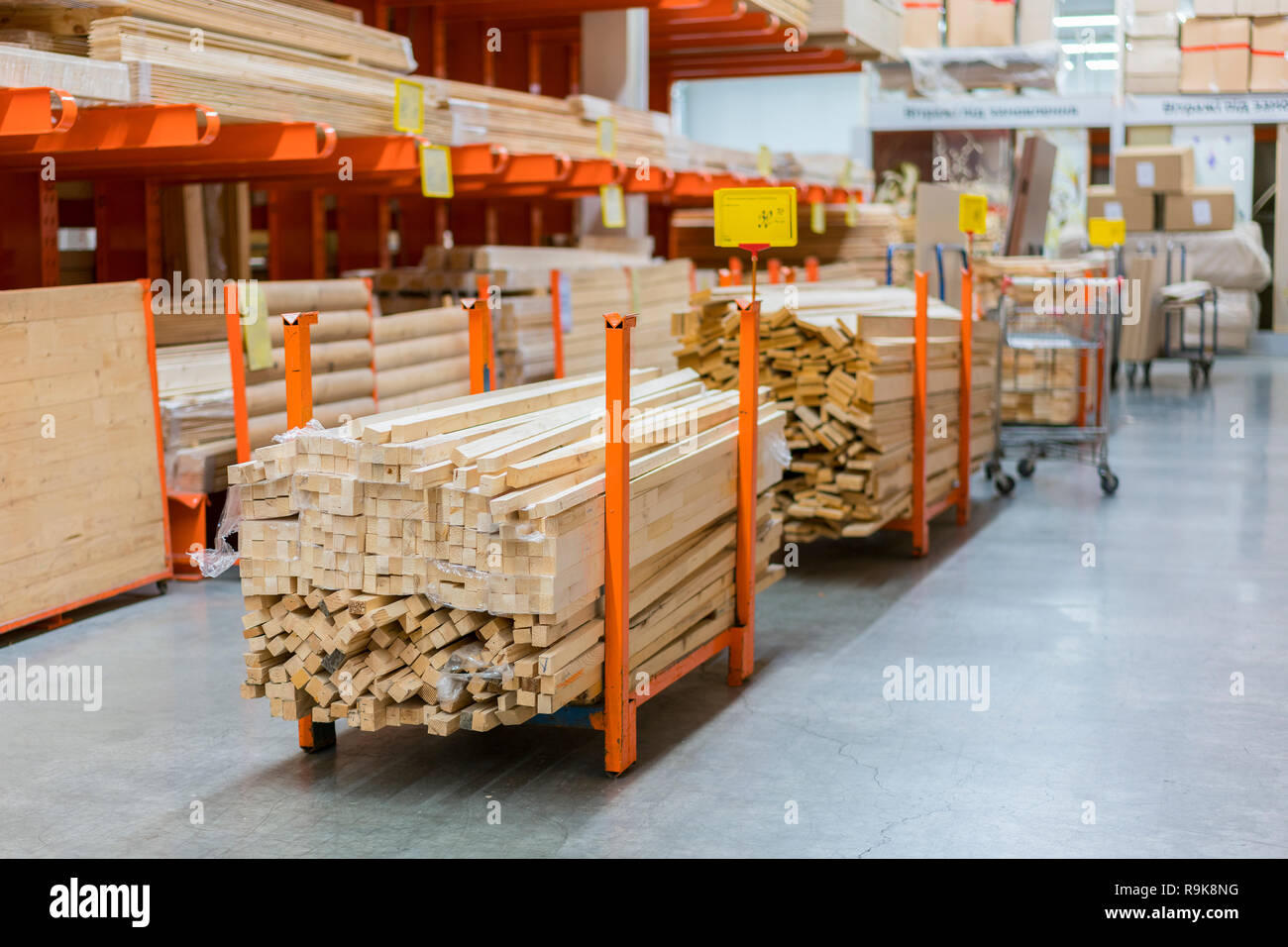 stack new wooden bars on shelves inside lumber yard of large hardware store in America. Rack of fresh mill or cut wood timber with flatbed cart and ma Stock Photo Alamy