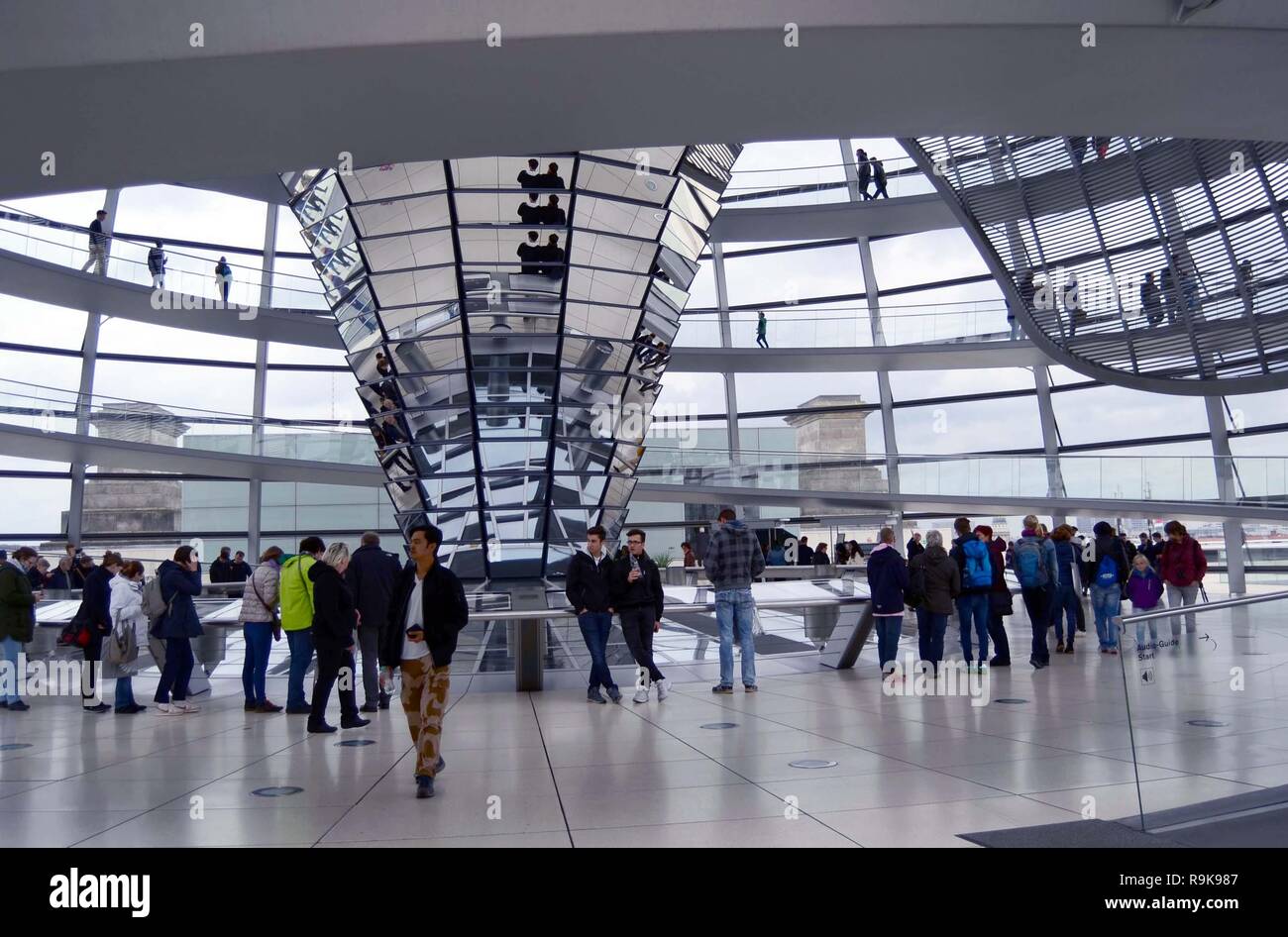 Inside view of visitors on the floor at the base of the mirrored cone ...