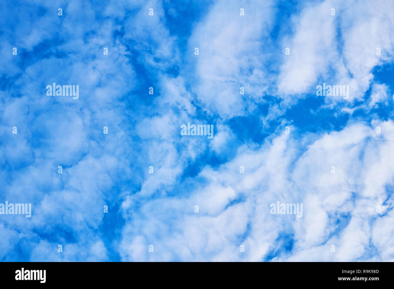 Saturated blue sky with clouds below Stock Photo - Alamy
