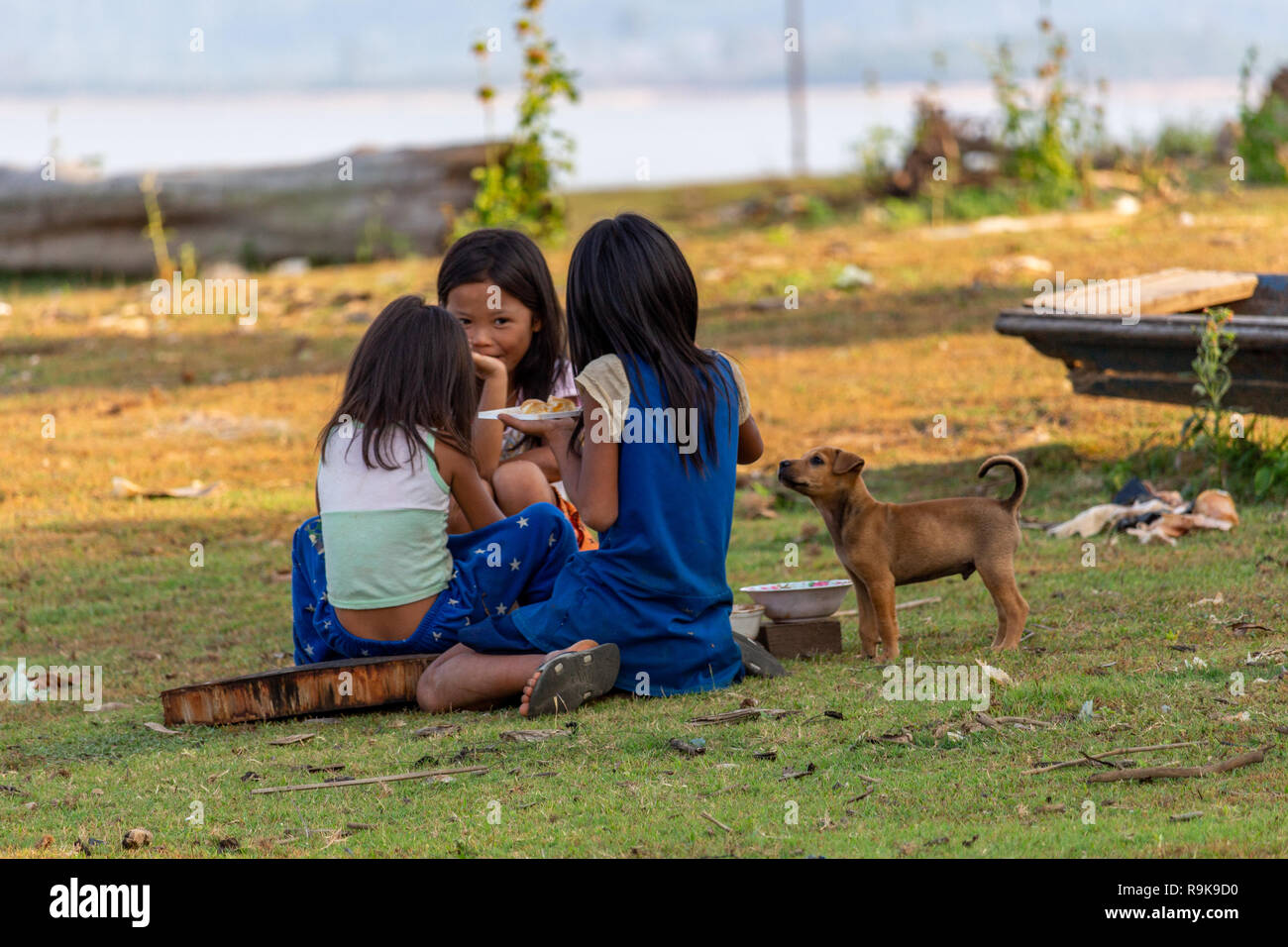 Thakhek, Laos - April 19 2018: Local kids playing to eat a meal they ...
