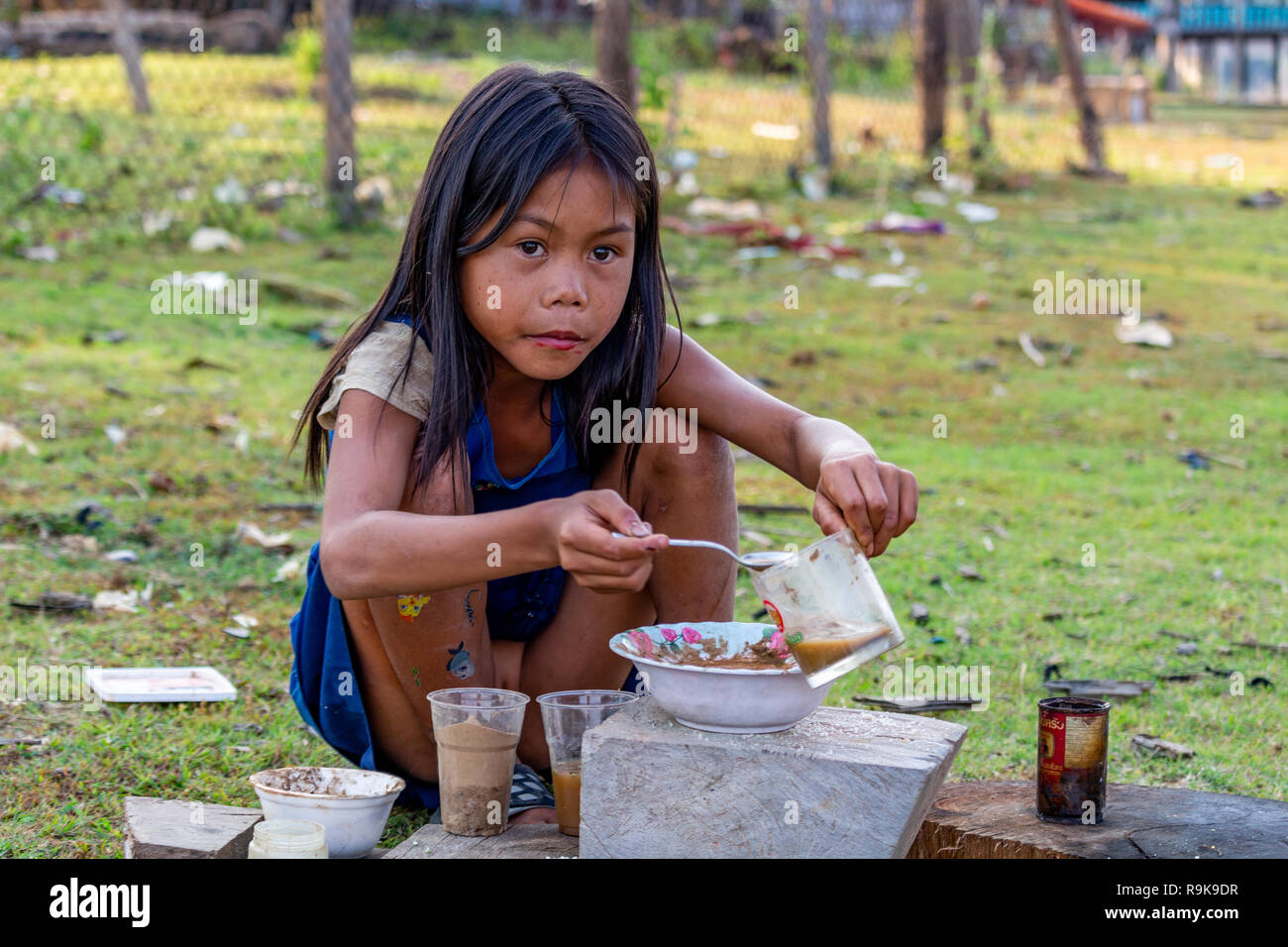 Thakhek, Laos - April 19 2018: Local chil playing to make a meal with ...