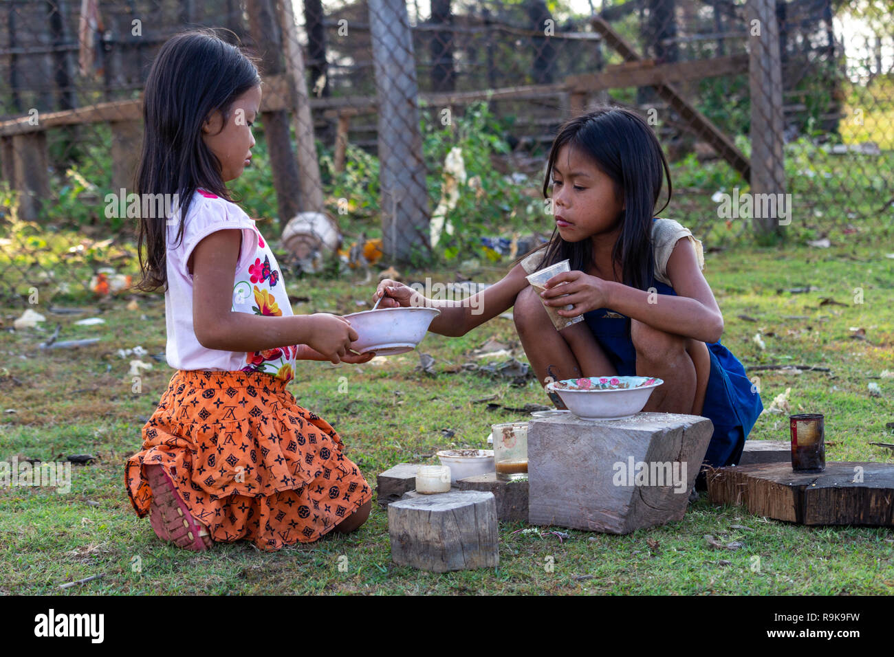 Thakhek, Laos - April 19 2018: Local children playing to cook a meal ... Thakhek, Laos - April 19 2018: Local children playing to cook a meal ...