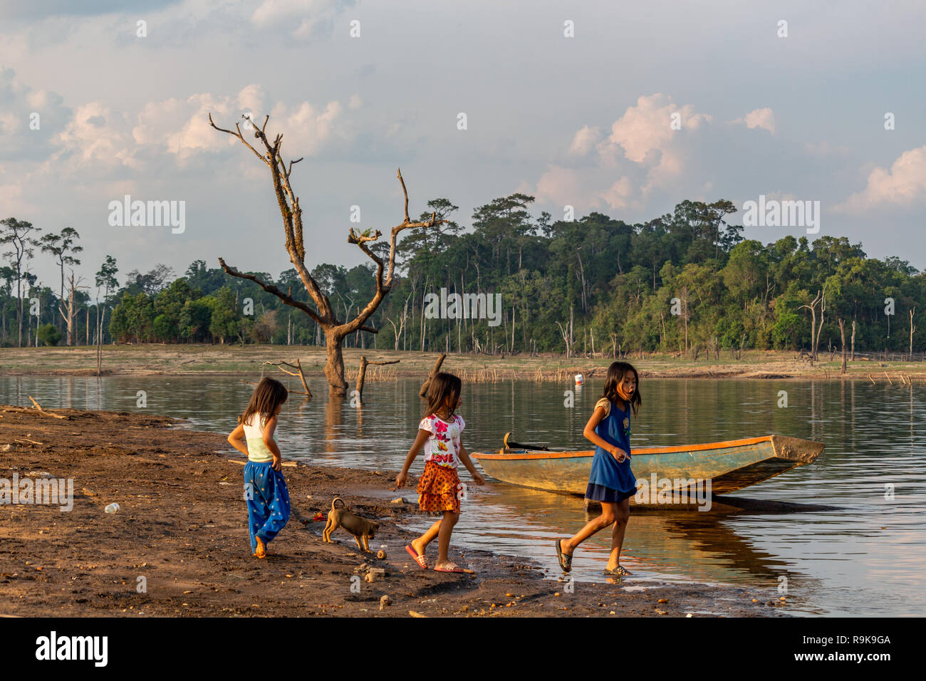 Thakhek, Laos - April 19 2018: Children and a dog walking through a ...