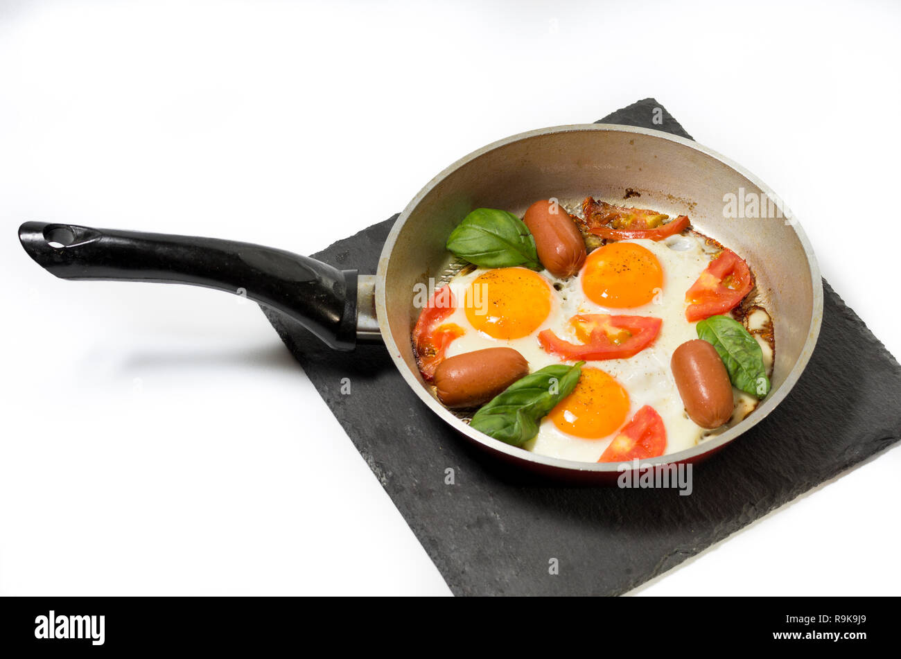 Pan with breakfast. Fresh breakfast. Fried eggs in the pan. Front view ...