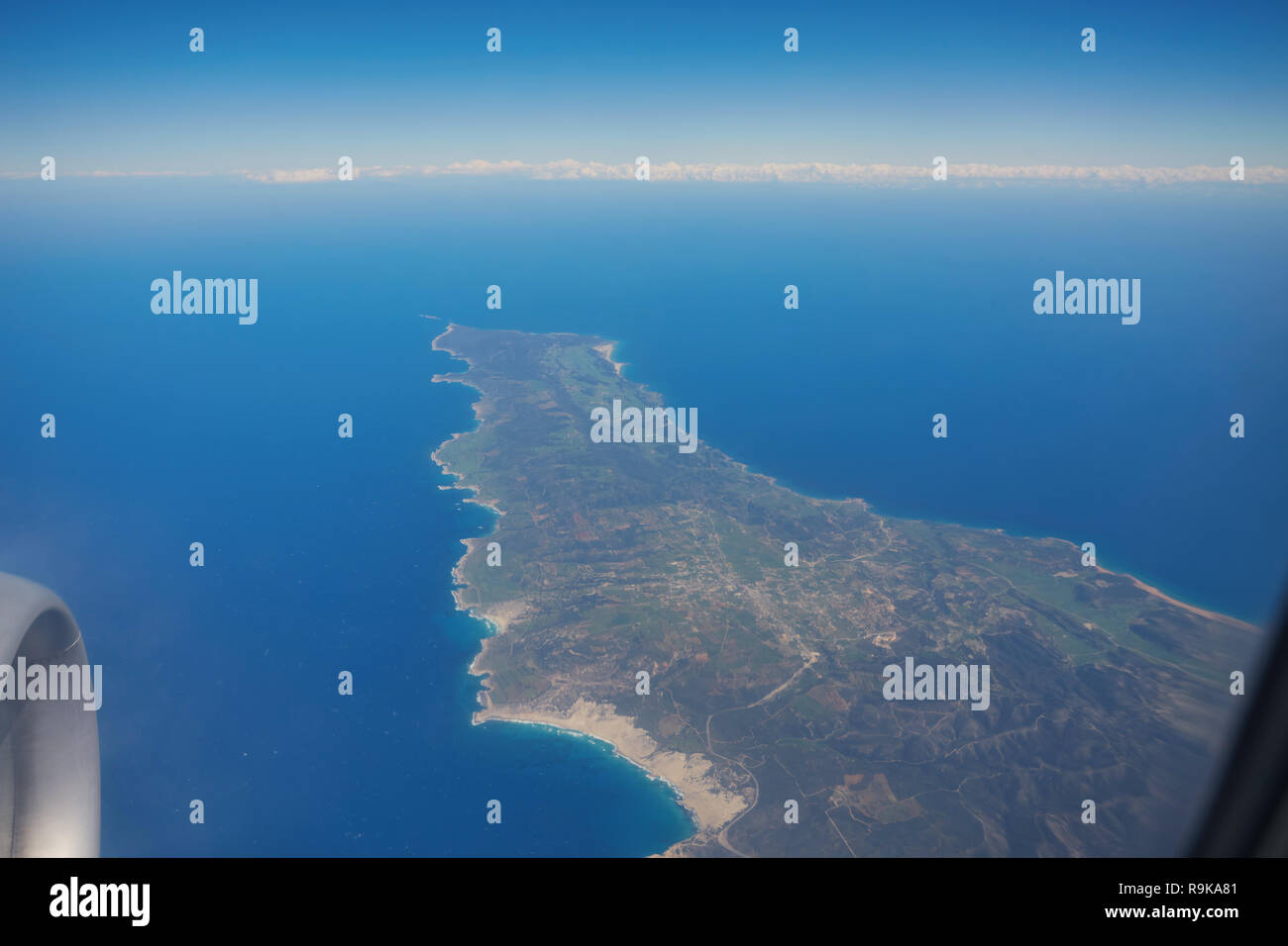 The plane is flying over the island of Cyprus. Airplane wing in flight ...