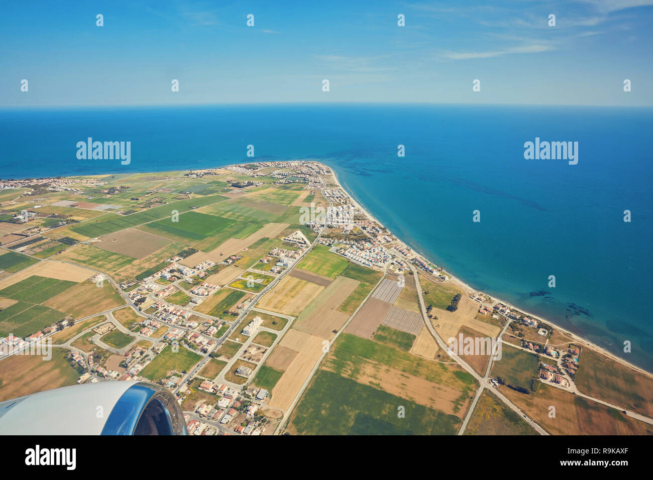 The plane is flying over the island of Cyprus. Airplane wing in flight ...