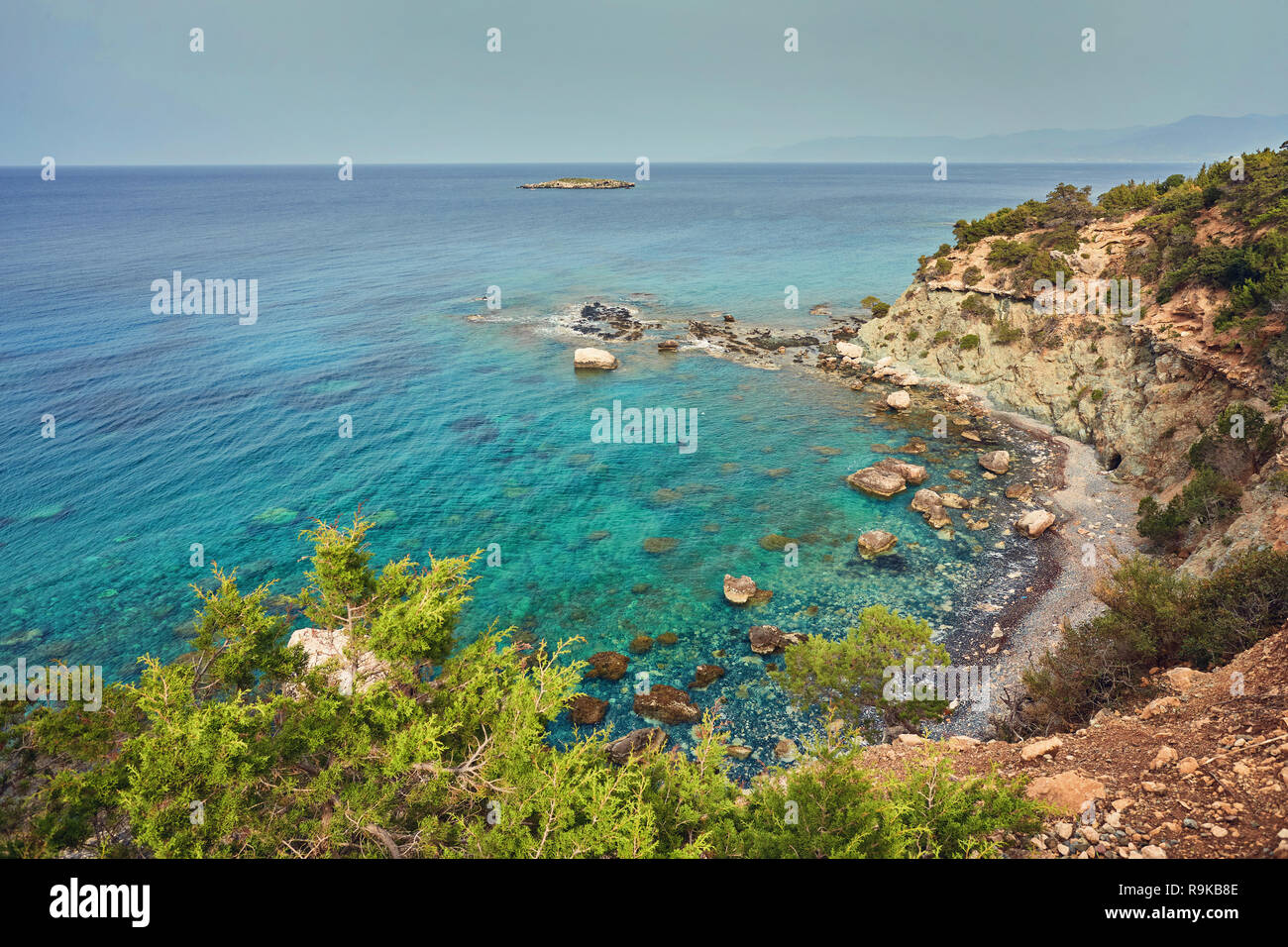 Stones and rocks in forefront with creamy surf ebbing and flowing on ...