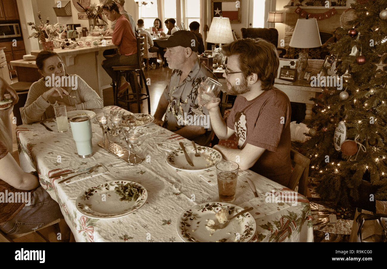 Family eating a holiday dinner with Christmas decorations Stock Photo ...
