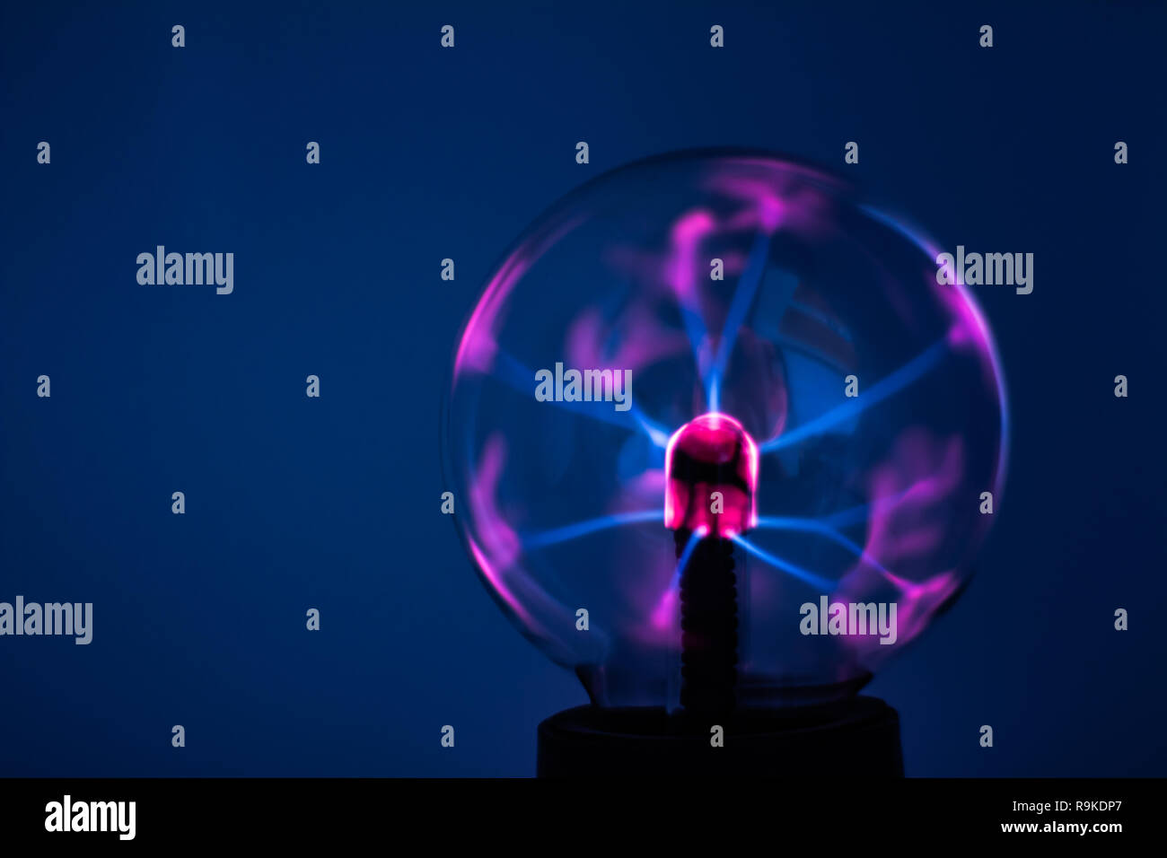 A plasma lamp with pink electricity rays. Effect of electricity on the ...