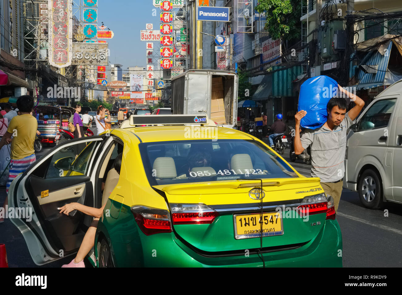 A taxi stopping in crowded and busy Yaowarat Road, Chinatown, Bangkok ...