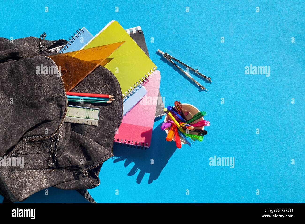 Overview of schhol bag and its content on a blue background. Backpack ...