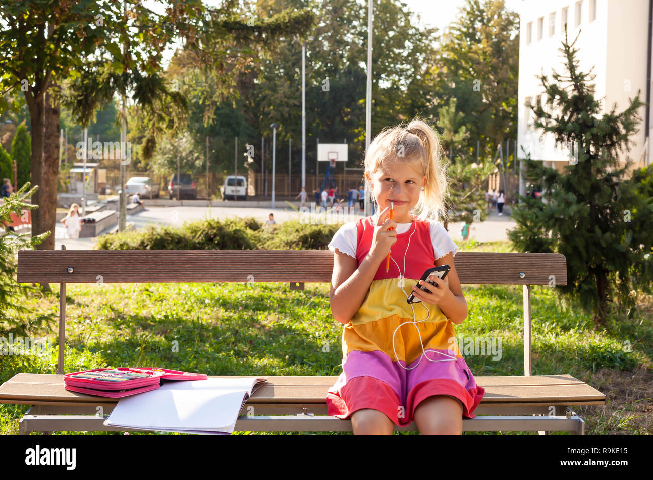 School girl is taking a break from lessons and sitting in the school ...
