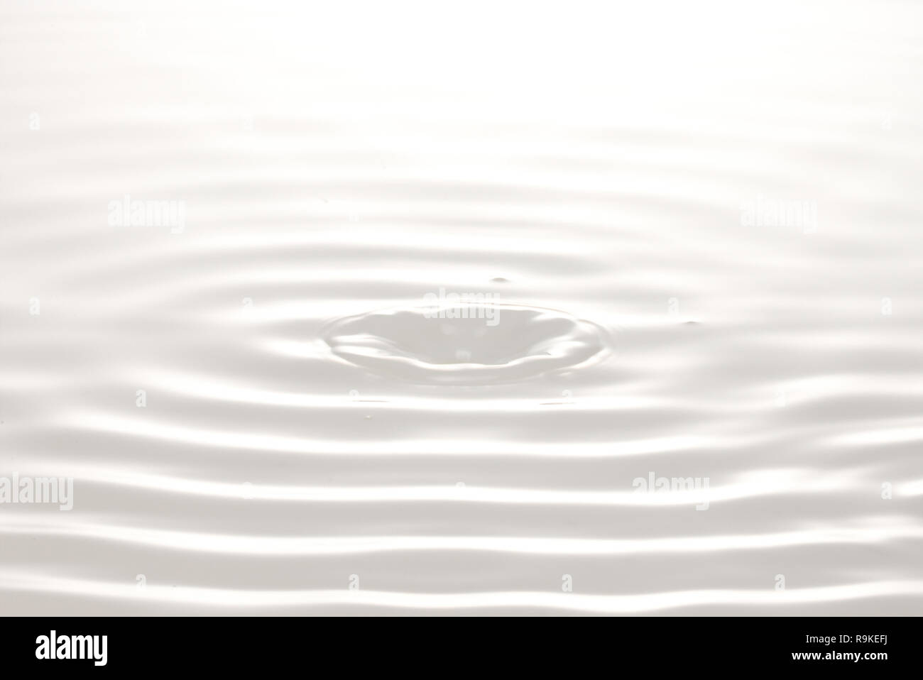 a wave after the drop of milk Stock Photo - Alamy