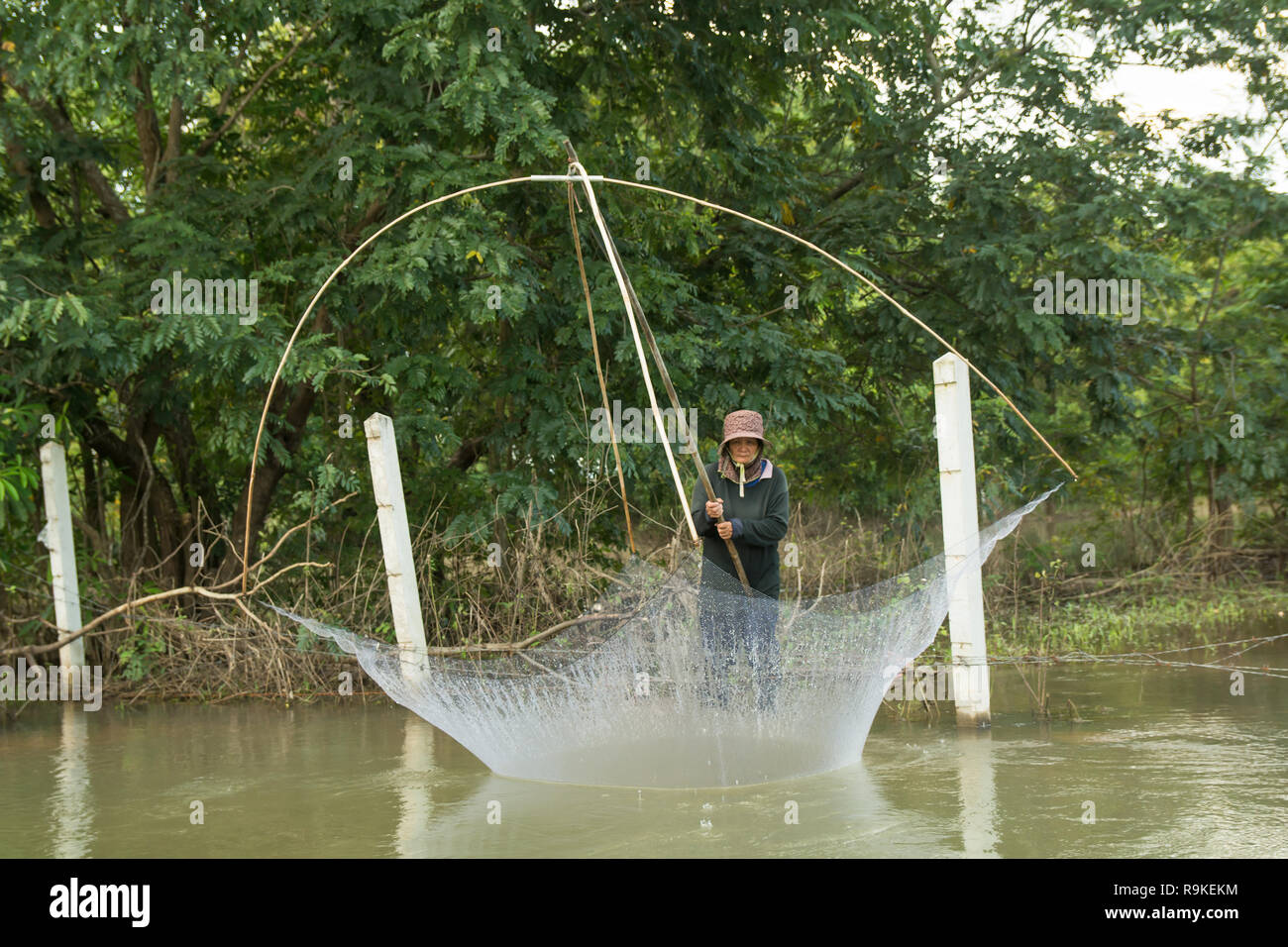 Nakhon Phanom, Thailand - 6 September 2018 : old woman catch fish with ...