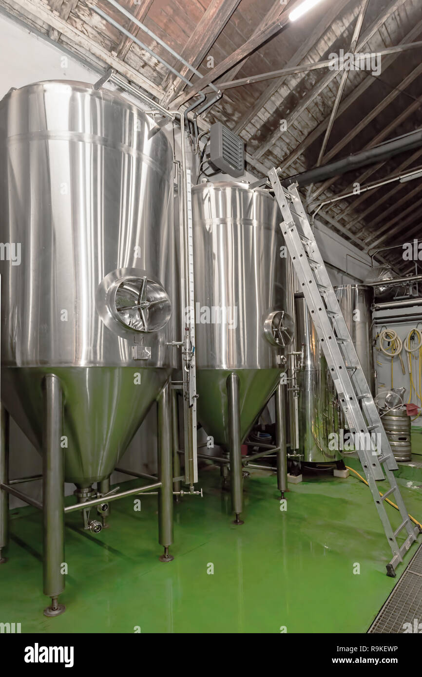Brewery. Modern beer plant with brewering kettles, tubes and tanks made ...