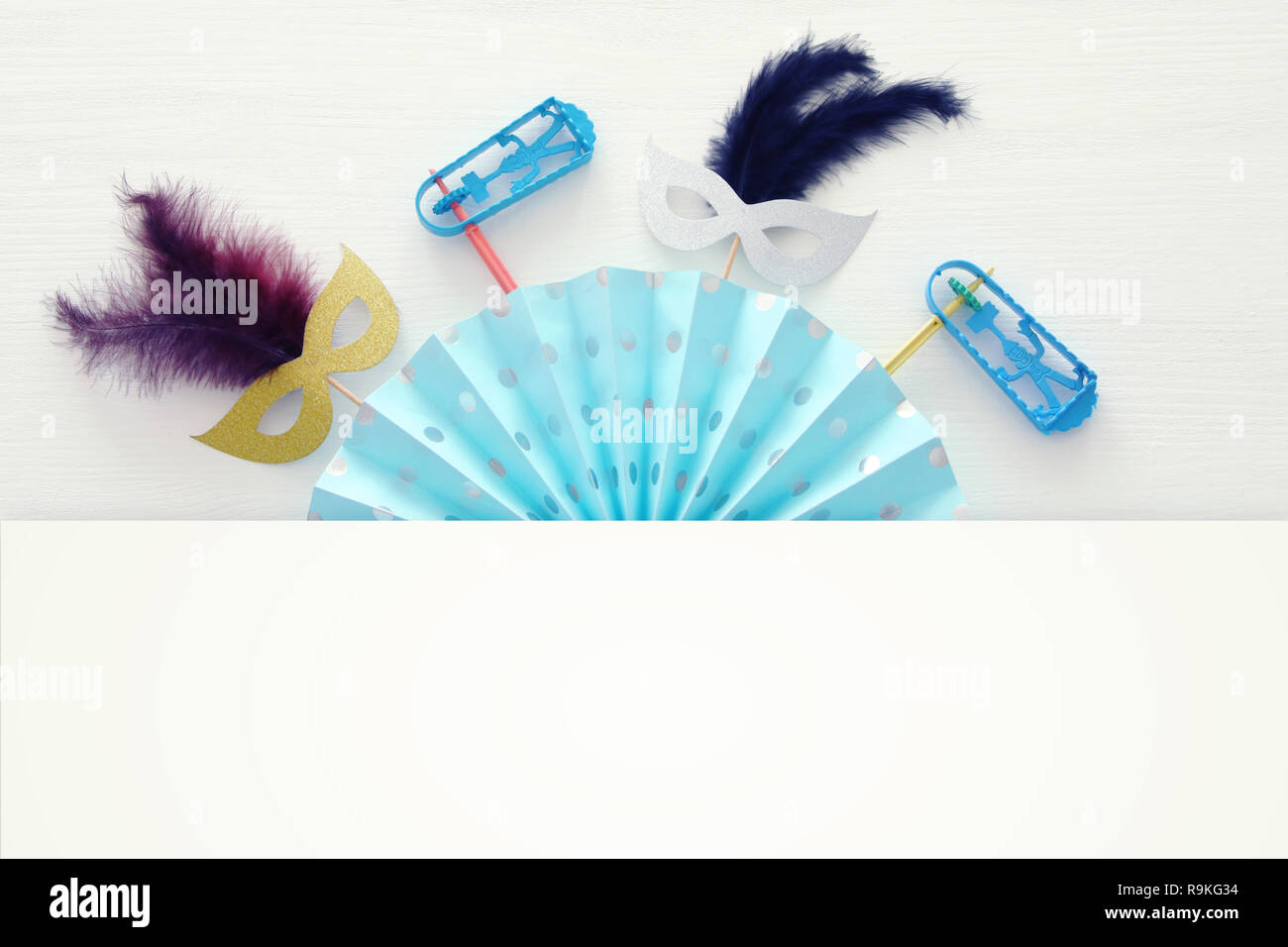 Purim celebration concept (jewish carnival holiday) over white wooden ...